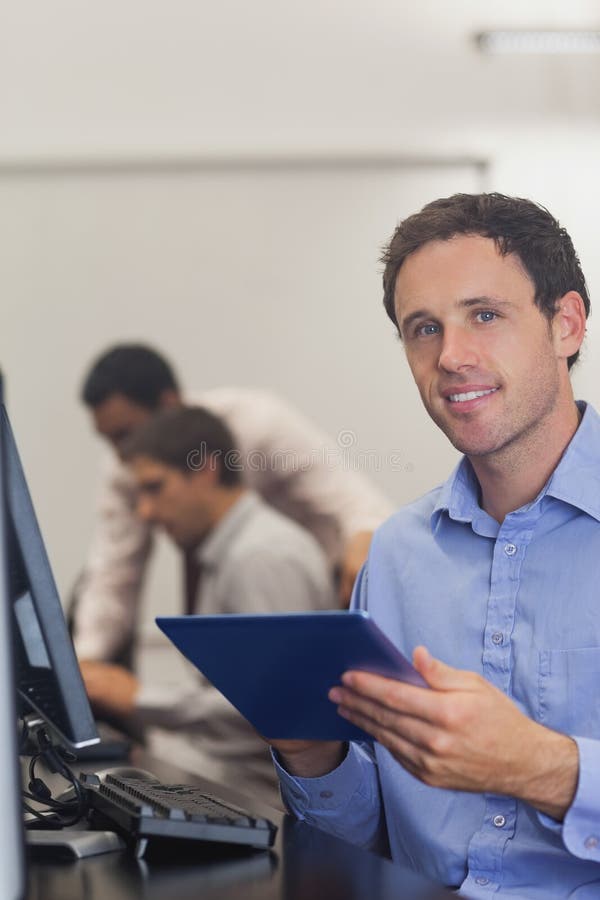 Content Male Student Holding His Tablet Sitting in Computer Class Stock ...