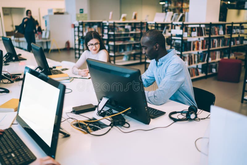 Content Multiracial Students Doing Homework Together and Using ...