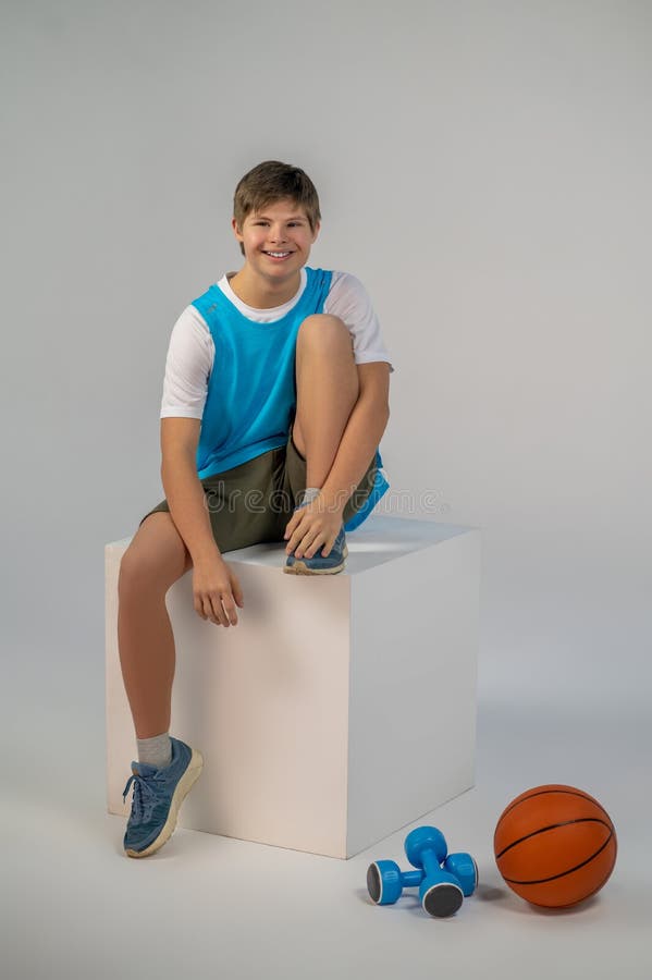 A Contented Boy Sitting on a Cube and Smiling Stock Image - Image of ...