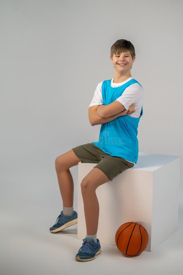 A Contented Boy Sitting on a Cube and Smiling Stock Image - Image of ...