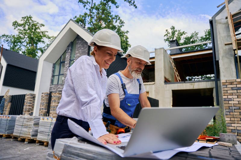 Construction Specialists Analyzing Site Development Plans Outdoors ...