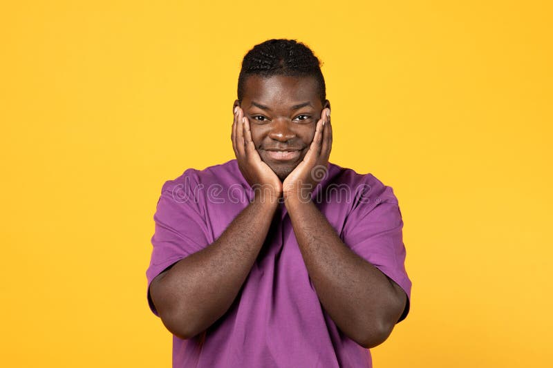 Contented Smiling Black Man Cupping Face in Hands, Yellow Background ...