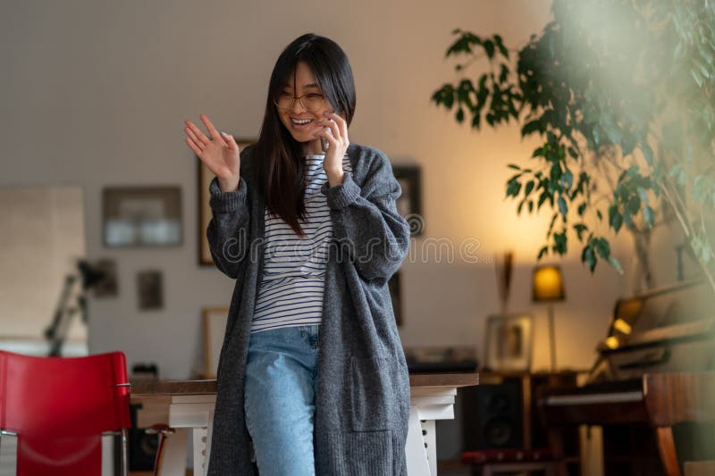Contented Young Asian Girl Talking on the Phone Stock Photo - Image of ...