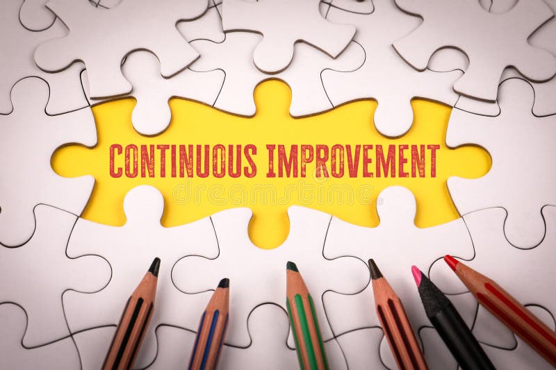 Continuous Improvement. White Puzzle Pieces and Colored Pencils Stock ...