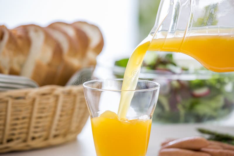 Continuous Pouring of Orange Juice for Breakfast Stock Photo - Image of ...