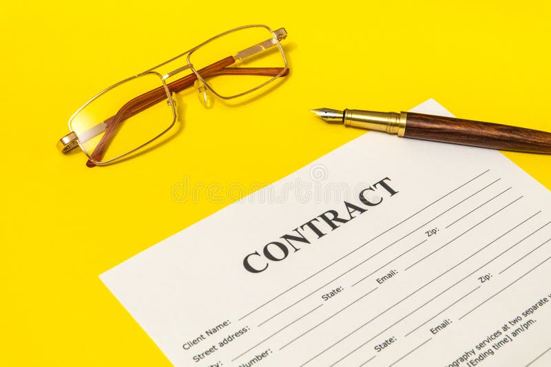 The Contract Form on the Yellow Office Desk with Glasses and Pen Stock ...