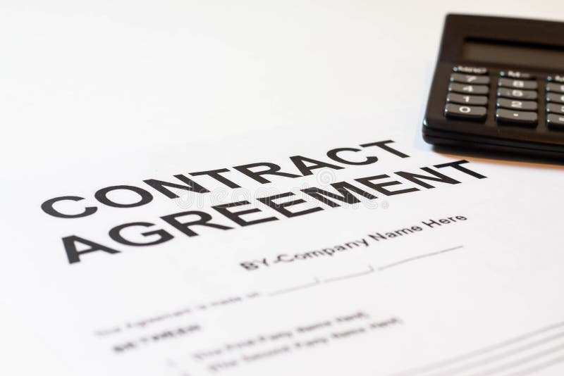 Contract Contract on a White Table Next To a Calculator Stock Image ...