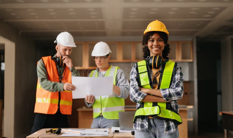 Contractor and Architect Looking at Plan, Tablet, Laptop and Talking ...