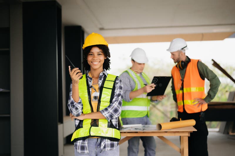 Contractor and Architect Looking at Plan, Tablet, Laptop and Talking about Working on Big ...