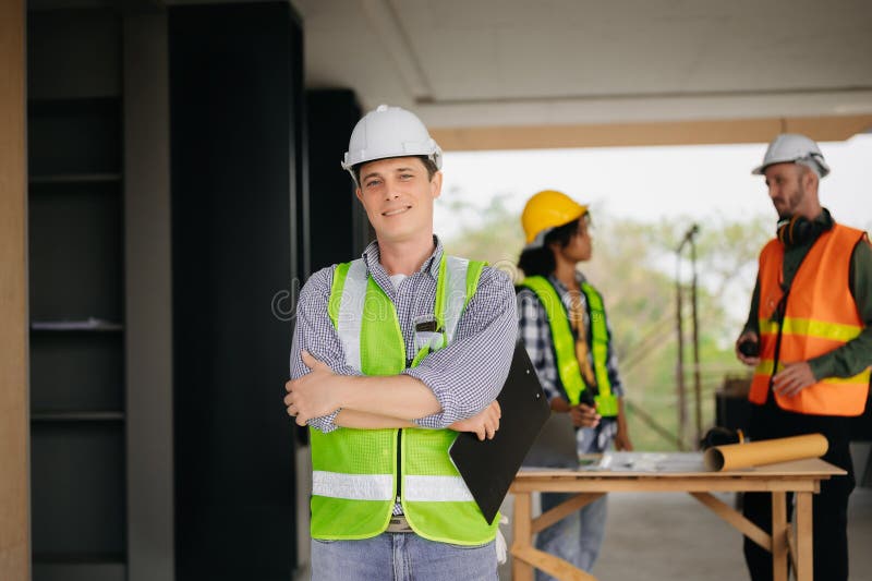 Contractor and Architect Looking at Plan, Tablet, Laptop and Talking ...