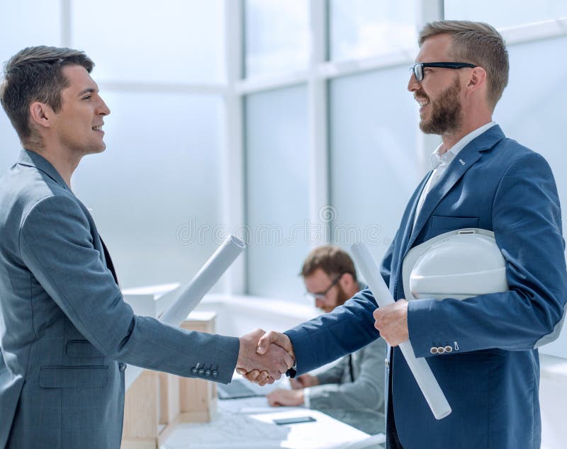 Contractor and Architect Shaking Hands in the Architectural Office ...