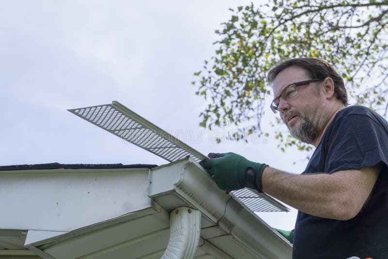 Contractor Examining Plastic Leaf Guard before Installation Stock Photo ...