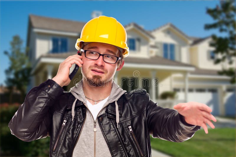 Contractor in Hard Hat on Phone in Front of House Stock Photo - Image ...