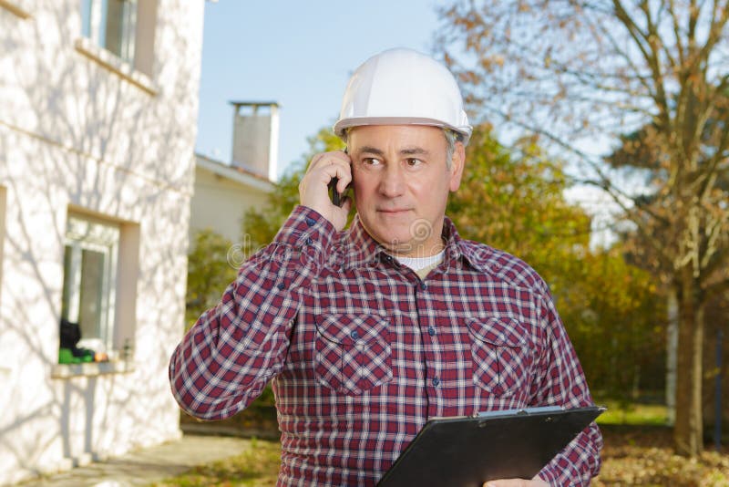 Contractor Holding Cost Information and Calling Stock Photo - Image of ...