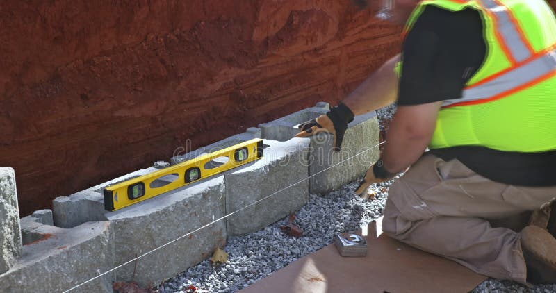 Contractor during the Installation of a New Large Block Retaining Wall ...