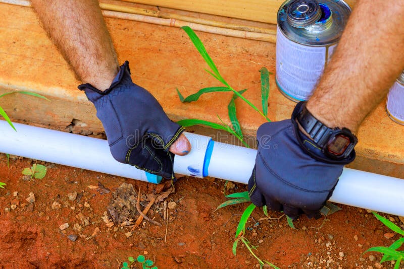 Contractor Installing Glues Plastic PVC Pipes for Laying a Water ...