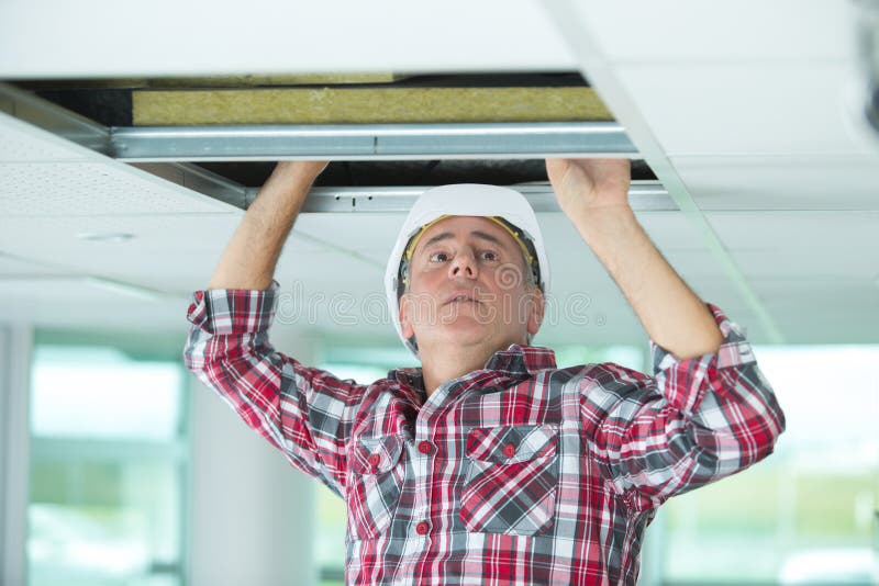 Contractor Lifting Ceiling Panel Stock Image - Image of building, panel ...
