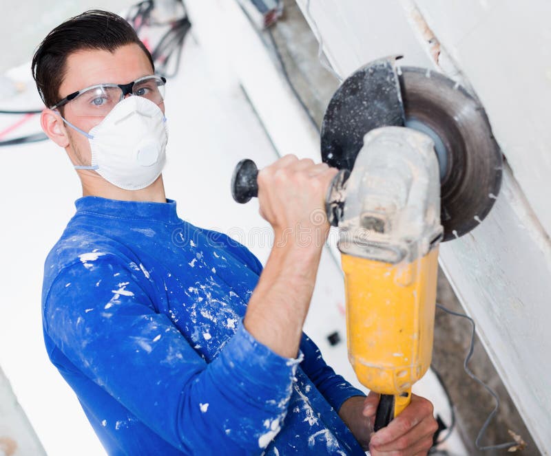 Contractor in Mask Using Professional Angle Grinder Stock Image - Image ...