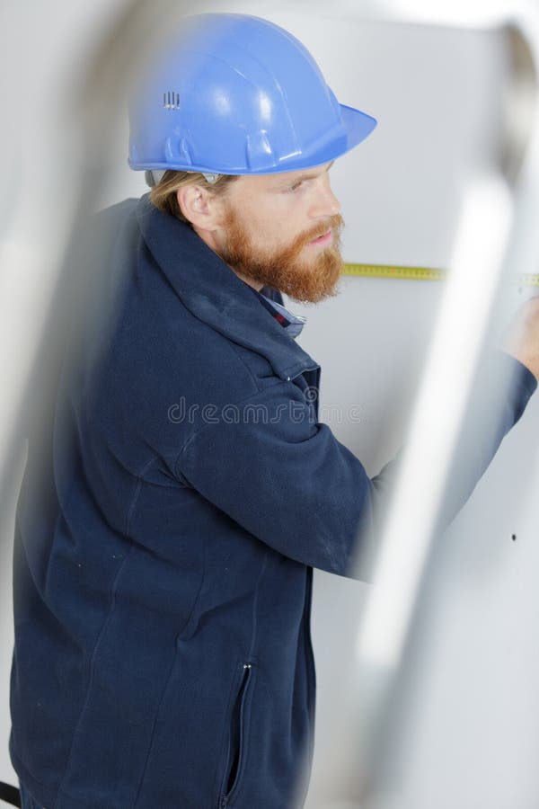 Contractor Measuring Wall Seen through Stepladder Stock Photo - Image ...