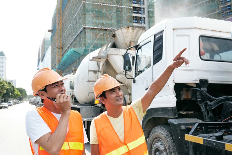 Contractor Pointing at Building Under Construction Stock Photo - Image ...