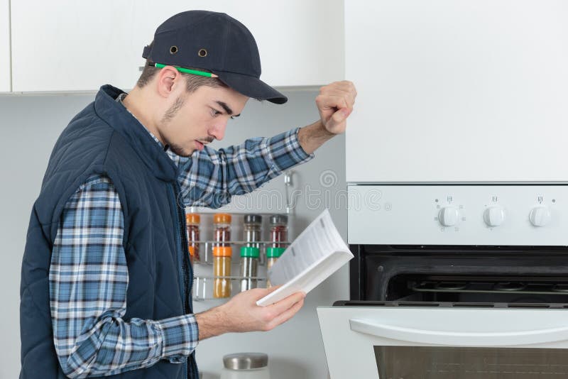 Contractor Reading Fitting Instructions for New Oven Stock Photo ...