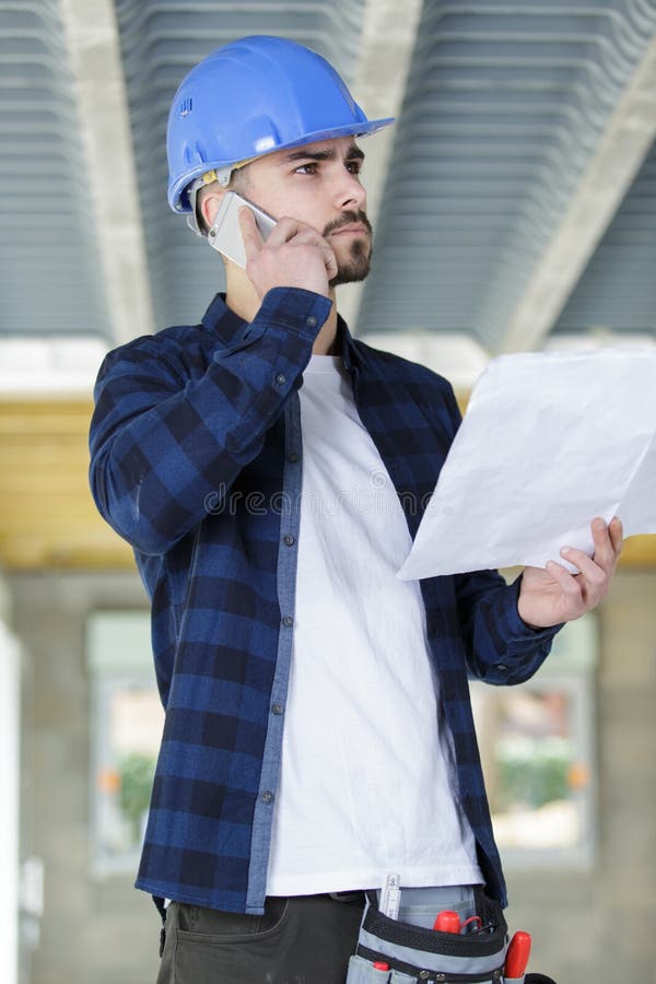 Contractor on Site Holding Plans and Making Telephone Call Stock Photo ...