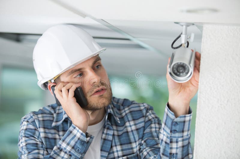 Contractor Talking on Telephone by Cctv Camera Stock Photo - Image of ...