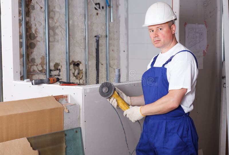 Contractor Using Angle Grinder Stock Image - Image of overhauls ...