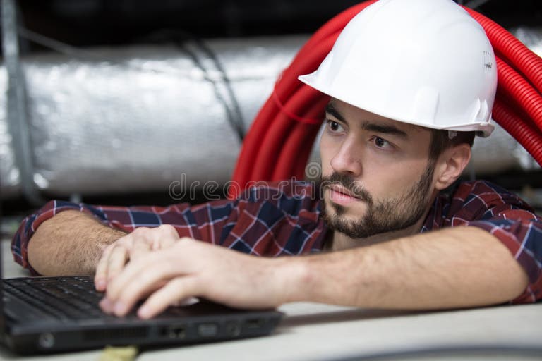 Contractor Using Laptop in Roofspace Stock Image - Image of ...