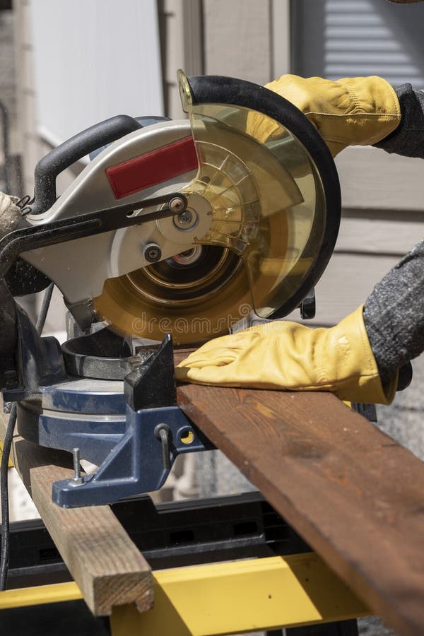 Contractor Using a Table Saw To Construct a Wood Screen in a Home Yard ...