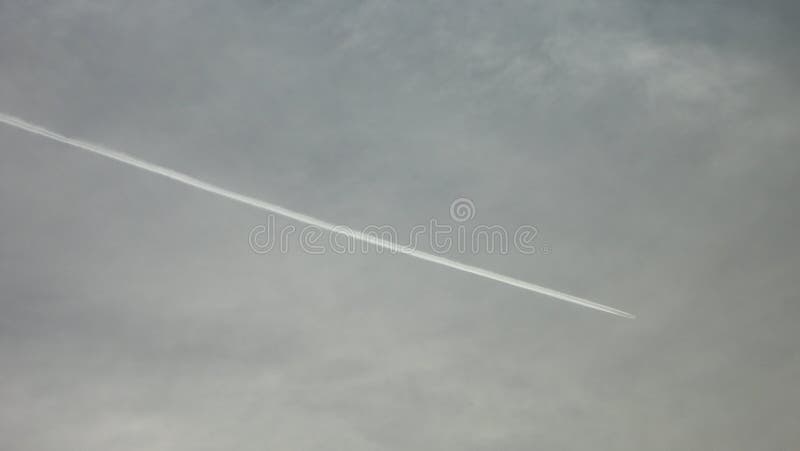 Contrail with cloudy sky stock photo. Image of condensation - 82909830
