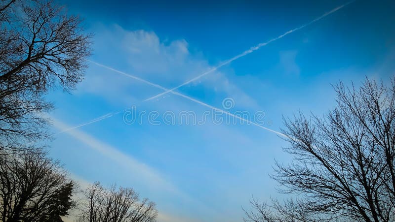 Contrail Flight Landscape Forming an X in the Sky Crossing. White on ...