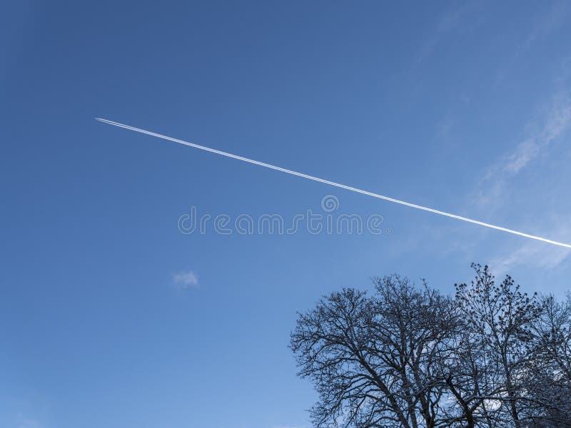 Contrail in winter sky stock photo. Image of countryside - 46861070