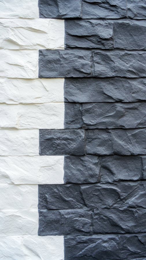 Contrasting Black and White Stone Wall with a Textured, Interlocking ...