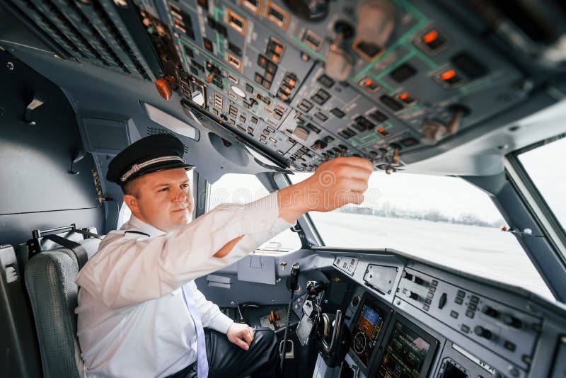 Control of the Flight. Pilot on the Work in the Passenger Airplane ...
