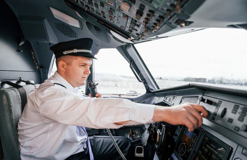 Control of the Flight. Pilot on the Work in the Passenger Airplane ...