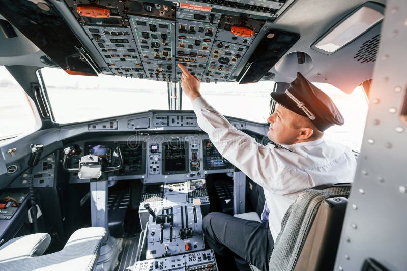 Control of the Flight. Pilot on the Work in the Passenger Airplane ...