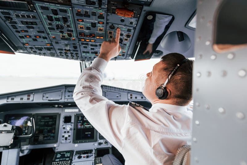 Control of the Flight. Pilot on the Work in the Passenger Airplane ...