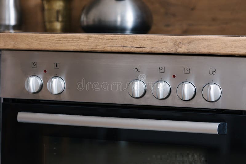 Control Panel of an Oven with Silver Knobs in a Stylish Kitchen. Stock ...