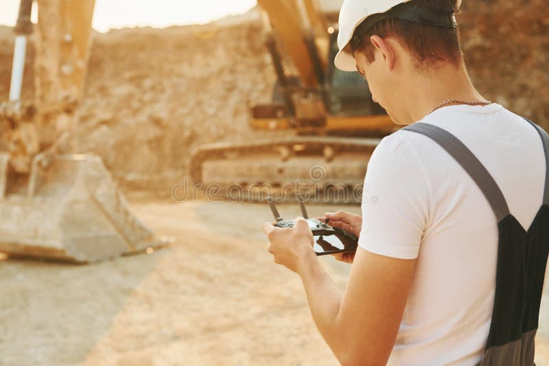 Control of the Project. Worker in Professional Uniform is on the Borrow ...
