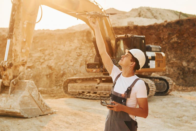 Control of the Project. Worker in Professional Uniform is on the Borrow ...