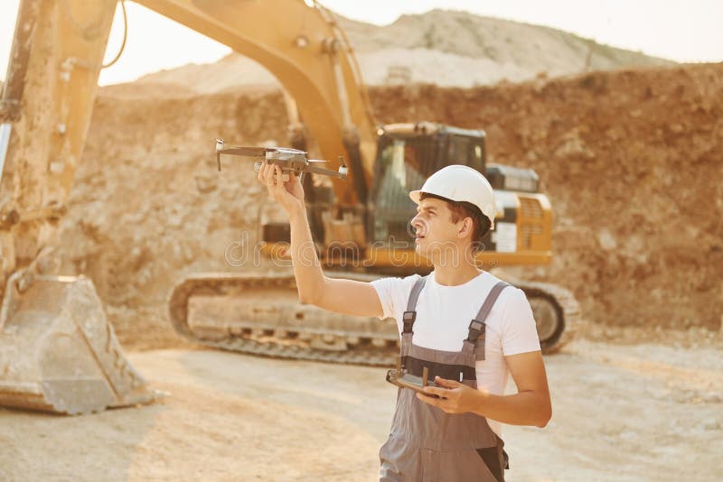 Control of the Project. Worker in Professional Uniform is on the Borrow ...