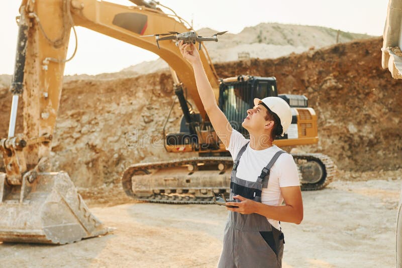 Control of the Project. Worker in Professional Uniform is on the Borrow ...