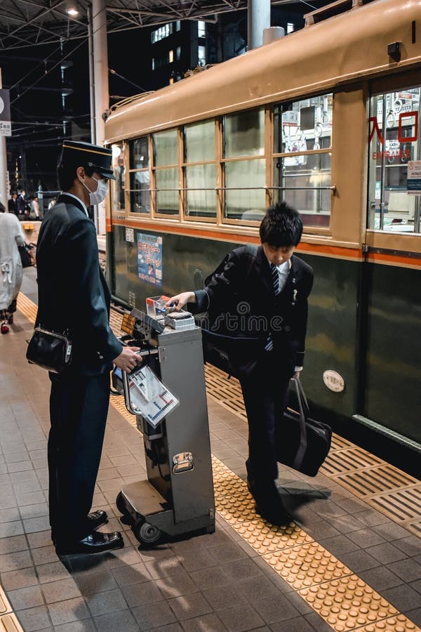Controller Controlling Tram Tickets Outside the Tram in Hiroshima Japan ...