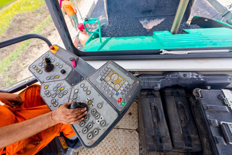 Controller Operates the Asphalt Spreading Machine, Adjusts Manually on ...
