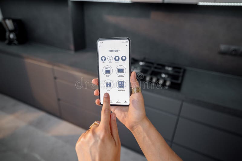 Controlling Smart Devices with Phone on the Kitchen Stock Photo - Image ...