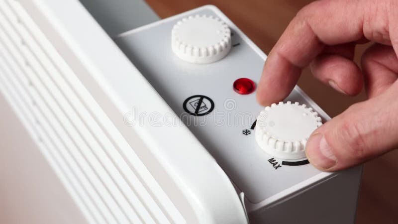 Adjusting Temperature on Thermostat Dial of Convector Heater. Stock ...