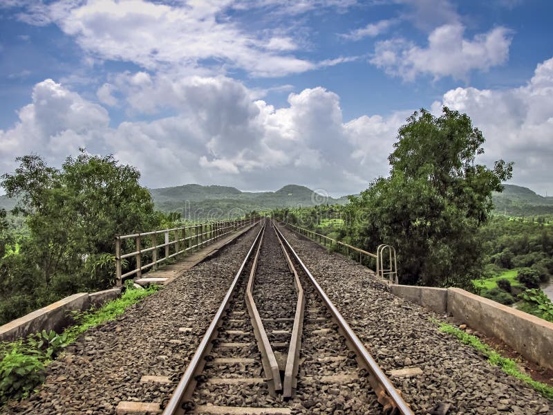 Converging Rail Track Over Bridge with Nice Blue Sky and Clouds ...