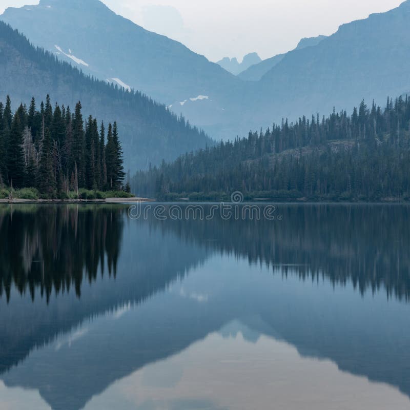 Converging Ridges with Glacier Mountains Over Lake Stock Photo - Image ...