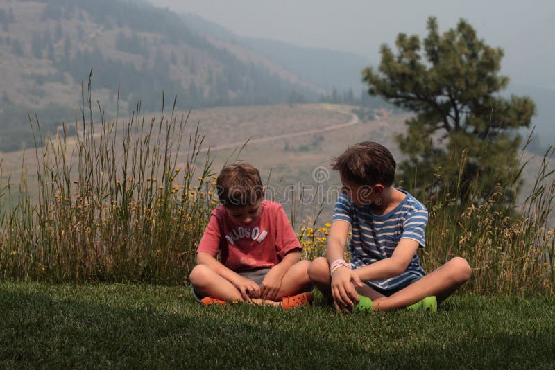 Conversation of Two Boys on the Grass Stock Photo - Image of confident ...